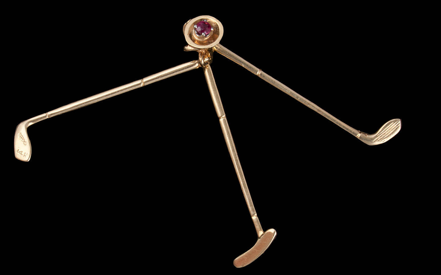 14K gold pendant with inset ruby, three dangling golf clubs