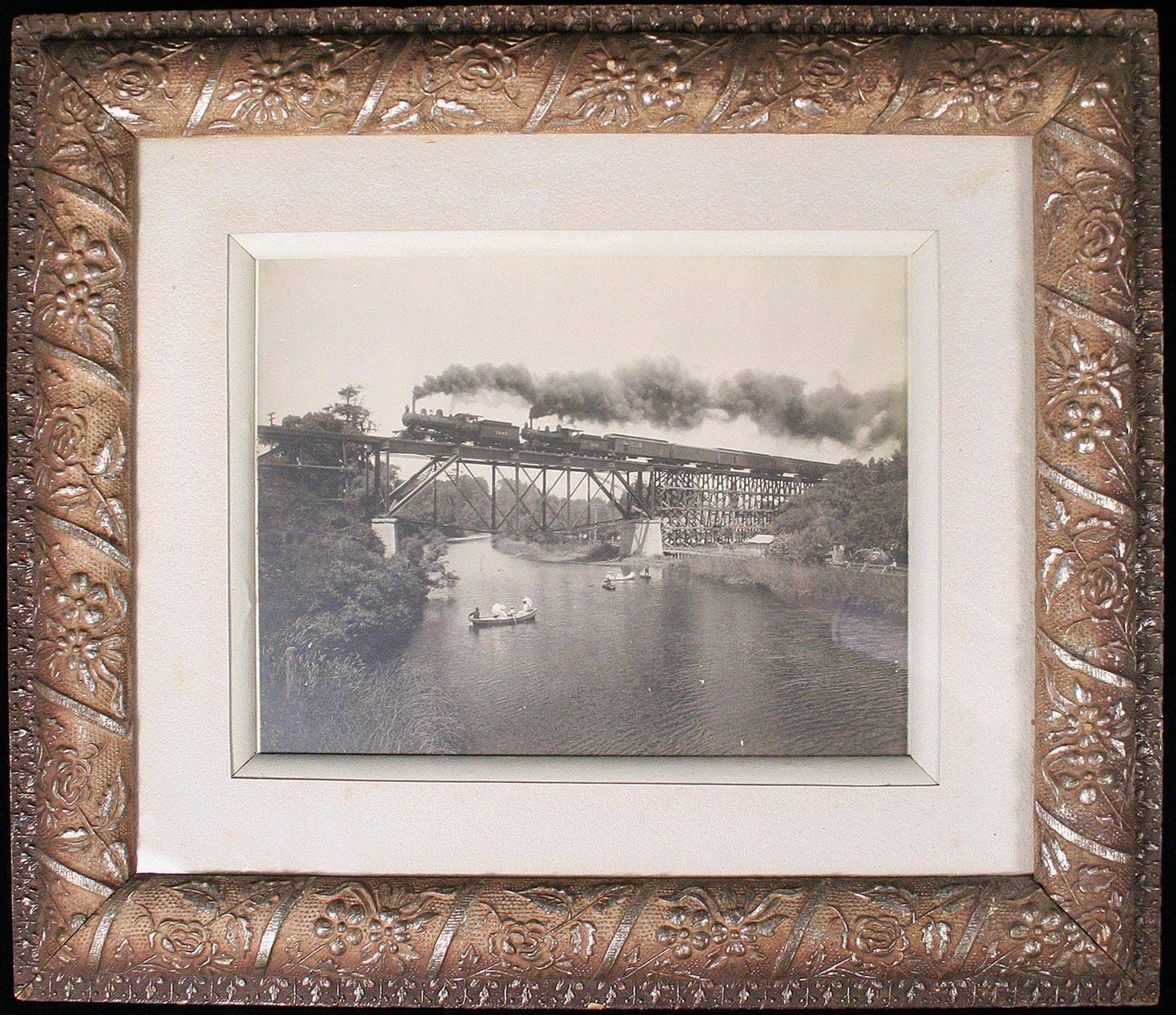 Silver photograph of a steam engine crossing a bridge in Capitola, with ...